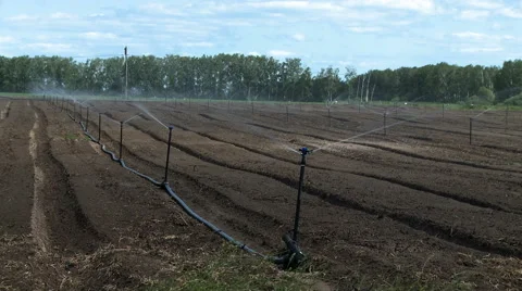 Irrigation system work on farm | Stock Video | Pond5
