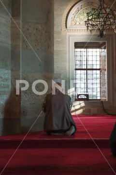 Islamic vertical photo. An elder muslim man praying in the mosque ...