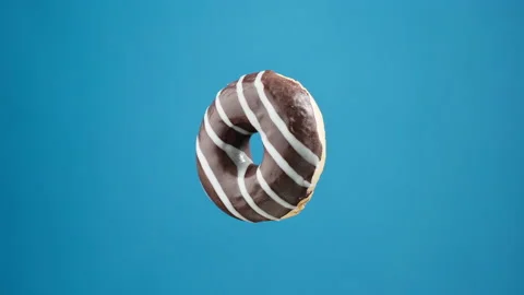 Isolated delicious donut rotating at blu... | Stock Video | Pond5