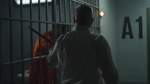 Jailer with police baton watches crimina... | Stock Video | Pond5