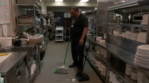 Janitor cleaning kitchen, wide shot | Stock Video | Pond5
