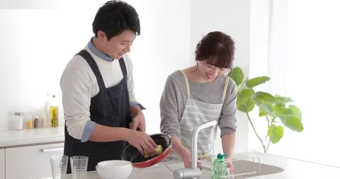 Japanese couple washing dishes in the ki... | Stock Video | Pond5