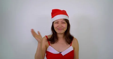 Japanese girl in sexy santa outfit waves | Stock Video | Pond5