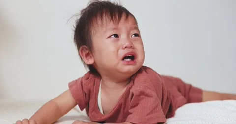 Japanese kid crying in bed | Stock Video | Pond5