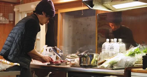 Japanese man cooking at a mountain cabin | Stock Video | Pond5