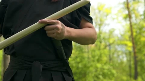 Japanese man, samurai, holds in his hand... | Stock Video | Pond5
