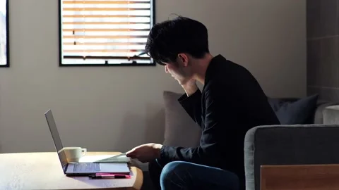 Japanese man working on the sofa in livi... | Stock Video | Pond5