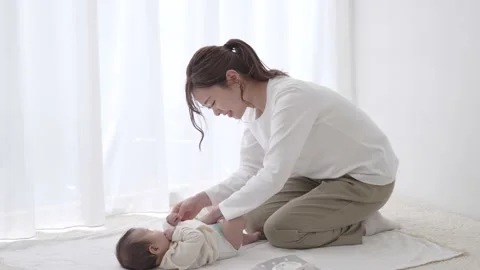 Japanese Mother Changing Newborn Diaper | Stock Video | Pond5