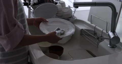 Japanese teenager washing dishes in a da... | Stock Video | Pond5
