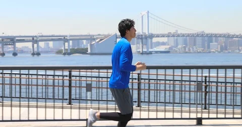 Japanese young man running on a sunny da... | Stock Video | Pond5