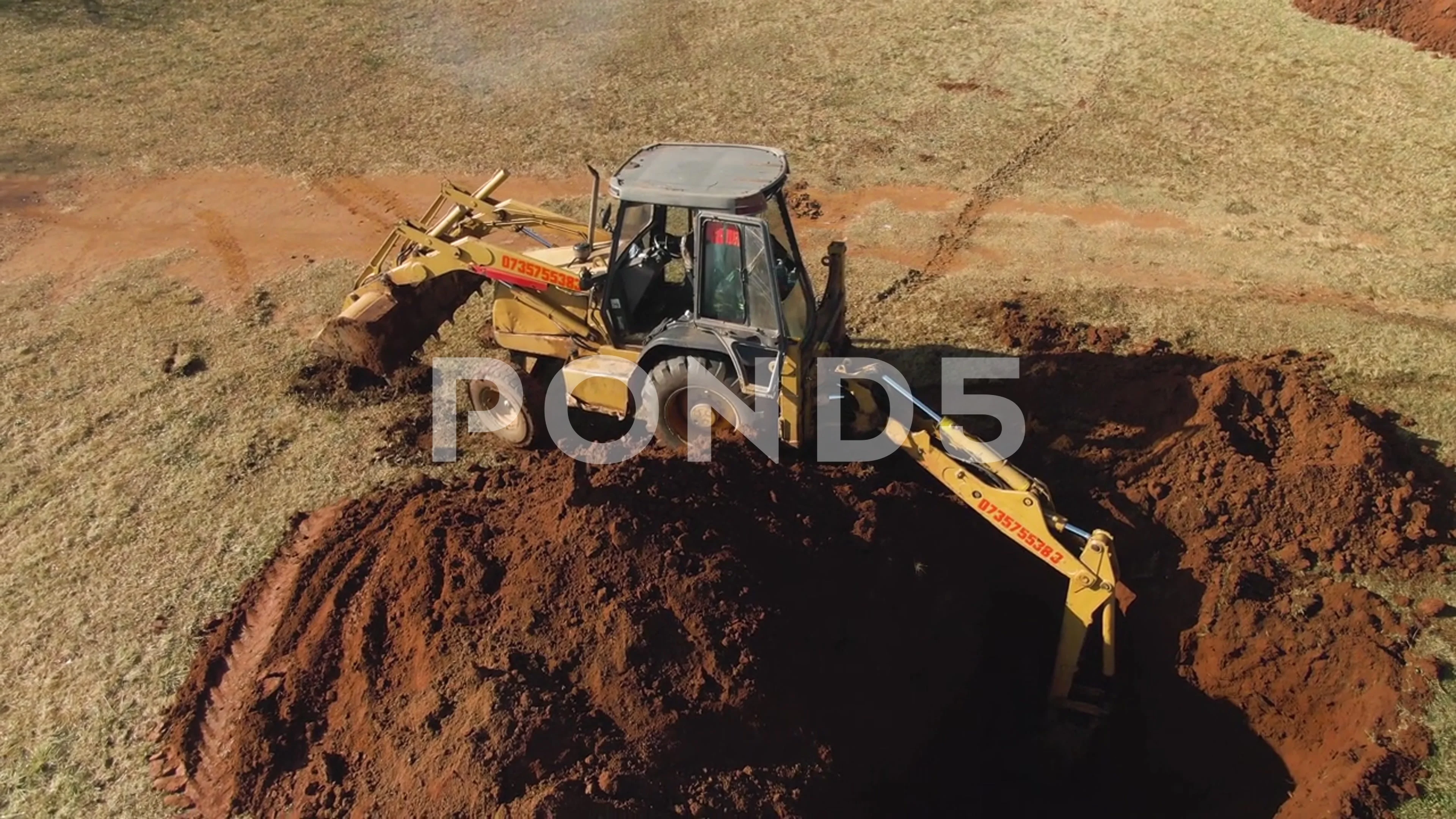 Backhoe Digging A Hole