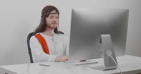 Jesus blowing a kiss to computer monitor | Stock Video | Pond5