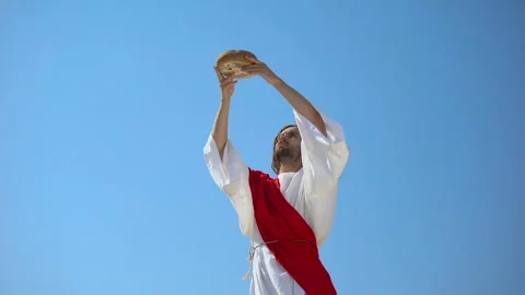 Jesus God raising bread in hands to sky,... | Stock Video | Pond5