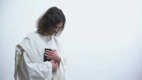 Jesus showing Holy Bible to camera, call... | Stock Video | Pond5
