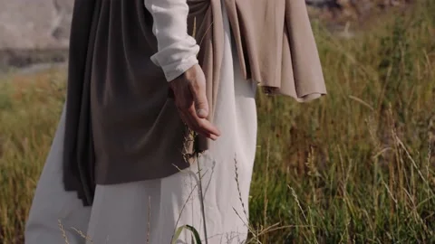 Jesus is walking on the grass, touching ... | Stock Video | Pond5