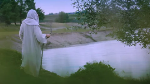 Jesus walking slowly near on the Jordan ... | Stock Video | Pond5