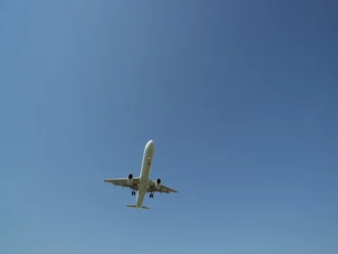 Jet airplane flying over head in blue sk... | Stock Video | Pond5