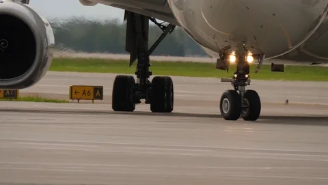 Jet engine and landing gear of taxiing a... | Stock Video | Pond5