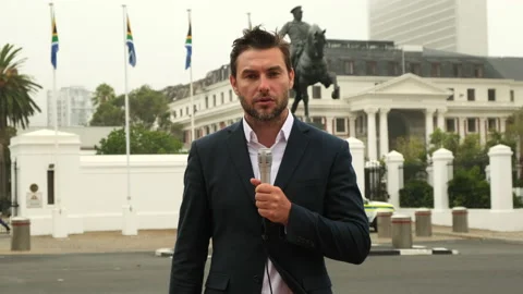 journalist gives an interview in front o... | Stock Video | Pond5