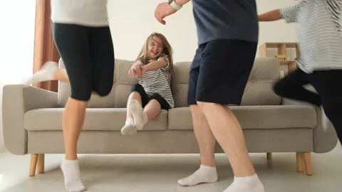 Joyful family running to the couch, youn... | Stock Video | Pond5