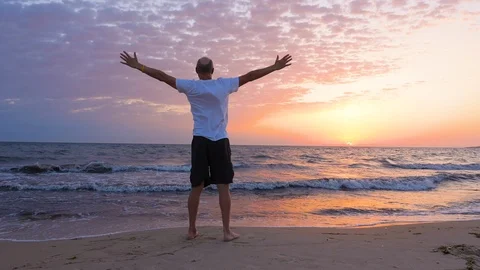 Joyful man rising up hands enjoying morn... | Stock Video | Pond5