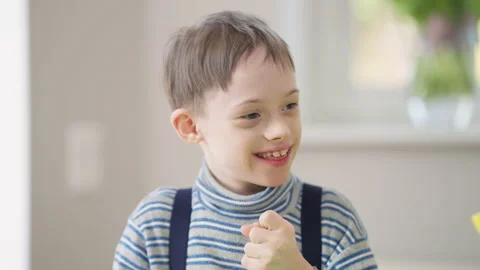 Joyful smiling autistic boy painting wit... | Stock Video | Pond5