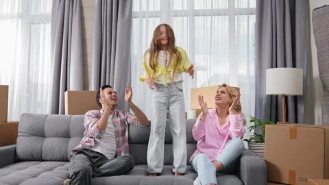 Joyful smiling family with kid moving in... | Stock Video | Pond5