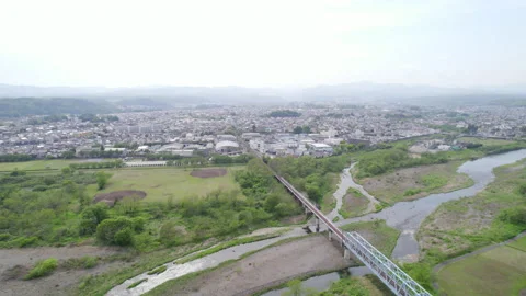 The JR Itsukaichi line in the city of Fu... | Stock Video | Pond5