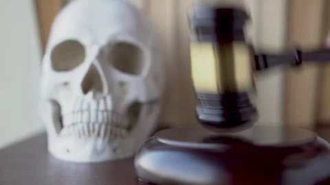 Judge gavel and a human skull in the bac... | Stock Video | Pond5