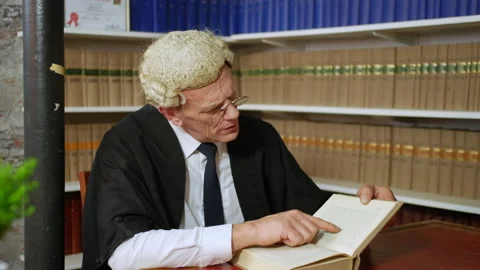 A judge or barrister reading in a law li... | Stock Video | Pond5