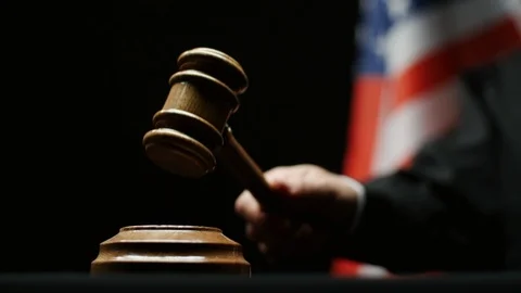 Judge's hand with wooden hammer against ... | Stock Video | Pond5