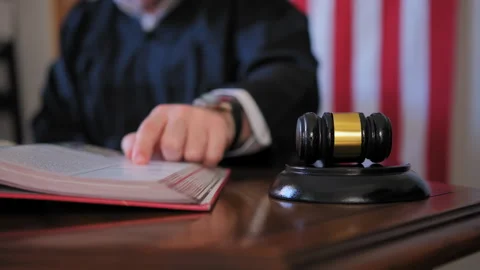 Judge's hand with wooden judge gavel and... | Stock Video | Pond5