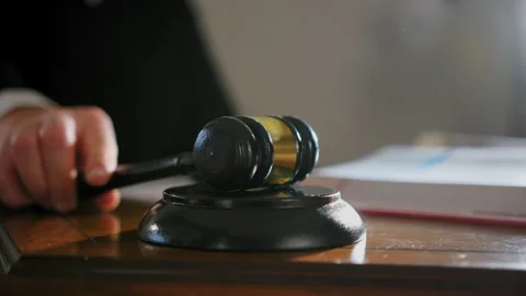 Judge's hand with wooden judge gavel and... | Stock Video | Pond5