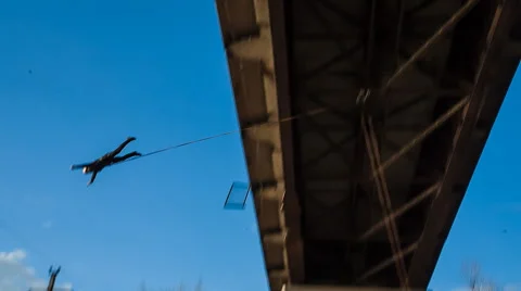 jump off a bridge on the background of b... | Stock Video | Pond5
