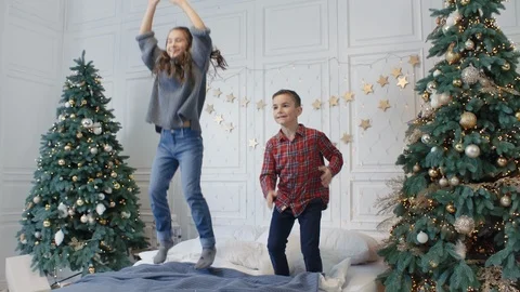 Jumping kids falling down on double bed ... | Stock Video | Pond5