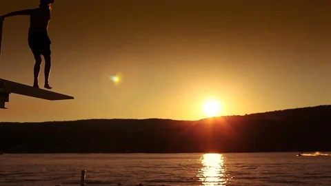 jumping in water from the jump board, su... | Stock Video | Pond5