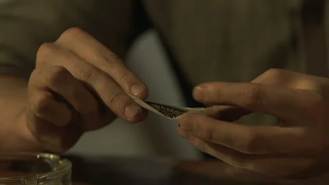 Junky male rolling marijuana weed, licki... | Stock Video | Pond5