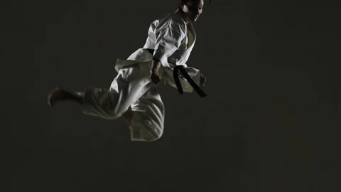 karate girl practicing jump kick, wearin... | Stock Video | Pond5