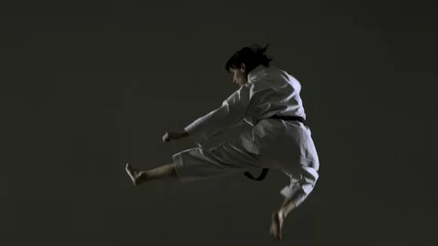karate girl practicing jump kick, wearin... | Stock Video | Pond5