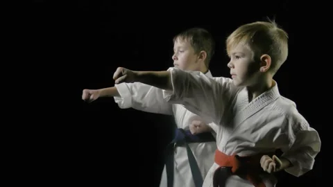 In karategi, boys hit punches on a black... | Stock Video | Pond5