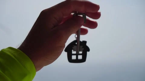 Keys with a house-shaped keychain in a m... | Stock Video | Pond5