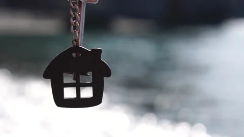 Keys with a house-shaped keychain in a w... | Stock Video | Pond5