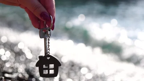 Keys with a house-shaped keychain in a w... | Stock Video | Pond5