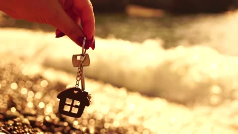 Keys with a house-shaped keychain in a w... | Stock Video | Pond5