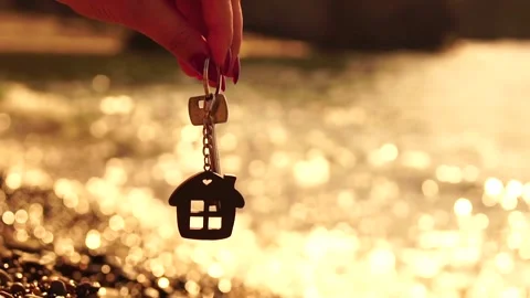 Keys with a house-shaped keychain in a w... | Stock Video | Pond5