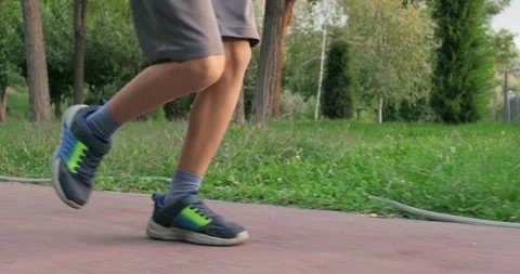 Kid boy athlete leg running in the park.... | Stock Video | Pond5