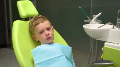 Kid crying in dental chair. Sad Caucasia... | Stock Video | Pond5