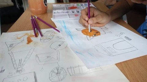 Kid drawing cartoon by pencil and waterc... | Stock Video | Pond5