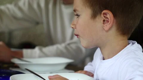 Kid Fooling Around At Lunch Table | Stock Video | Pond5