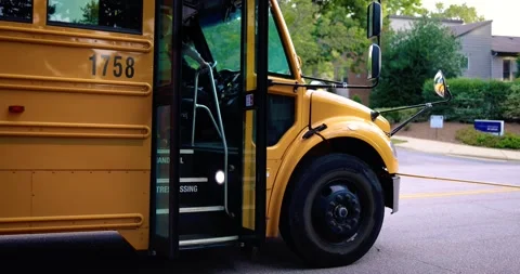 kid is getting on the bus, ready to go t... | Stock Video | Pond5